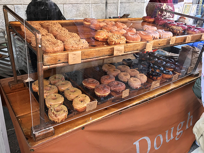 The Dough display case&mdash;where willpower goes to die. These artisanal donuts make waiting in line a spiritual practice worth every minute.