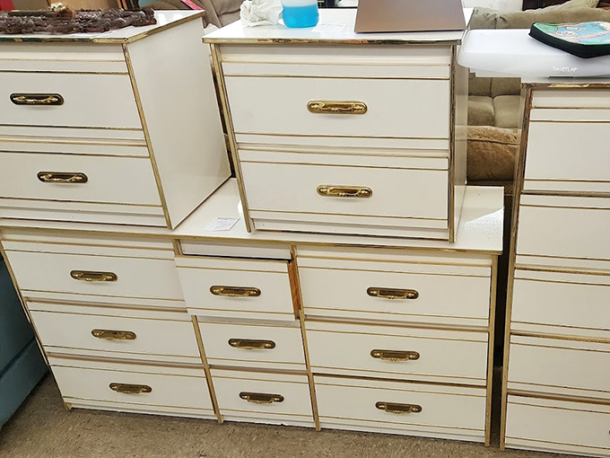 White dressers with gold handles stand at attention like an army of storage solutions, each drawer holding potential for organization revolution.