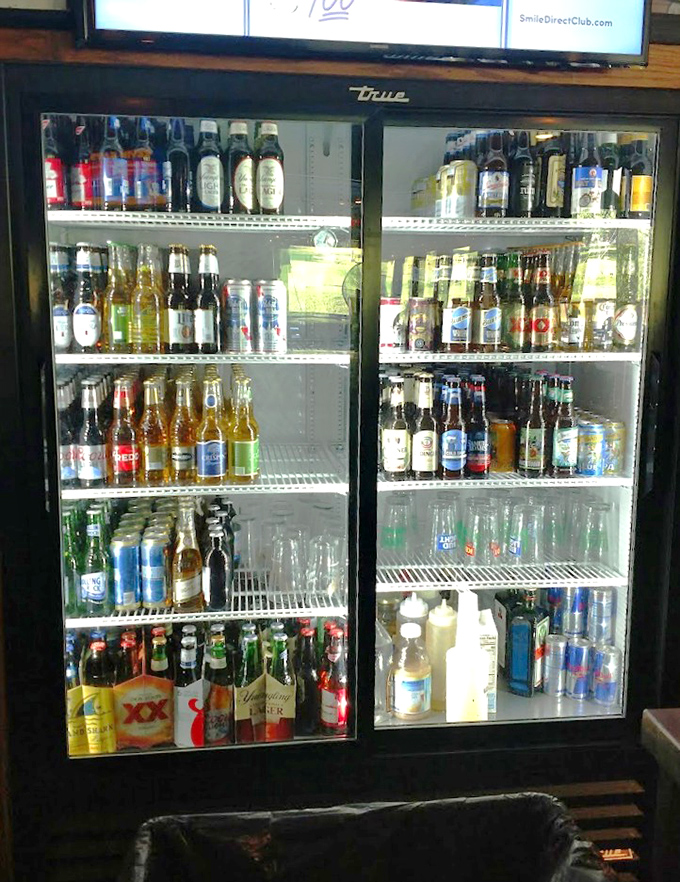 The beer fridge: a chilled gallery of liquid artwork ranging from everyday classics to craft creations, all promising the same happy ending.
