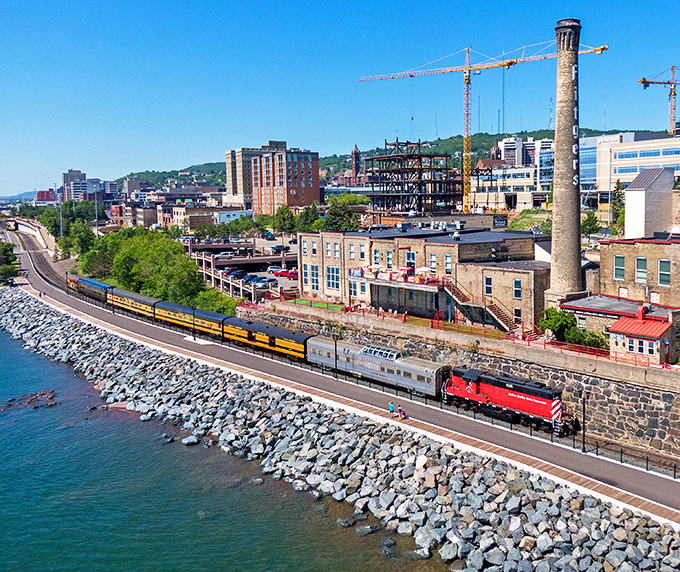 The cityscape unfolds as the train hugs the shoreline &ndash; Duluth's industrial heritage and natural beauty creating a uniquely Minnesotan tableau.