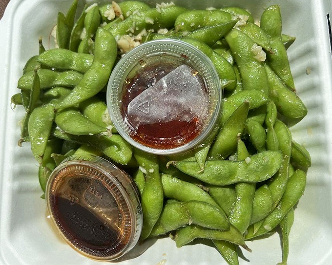 These edamame pods, glistening with sauce, are the opening act that somehow manages to upstage even the headlining shrimp.