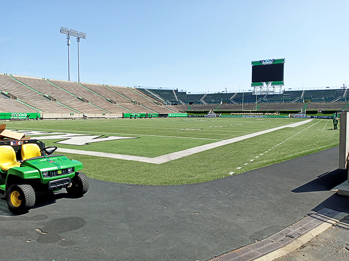 Marshall University's stadium stands ready for game day glory. The empty seats hold the echoes of thousands of passionate fans from seasons past.
