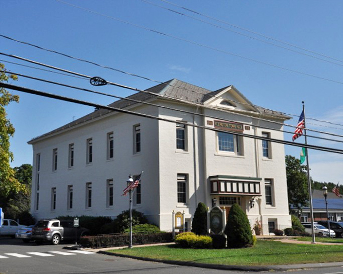 The stately Town Hall stands as a reminder that even small-town government deserves dignified architecture and plenty of parking.