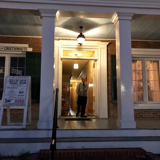 The evening entrance glows with warm light, beckoning brave souls to discover what waits inside after dark.