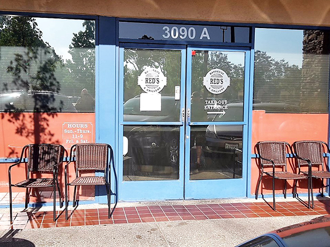 The blue doors of barbecue paradise, flanked by waiting chairs for those who understand that good things come to those who wait for smoked meat.