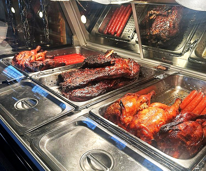 The meat counter reveals the full spectrum of smoked delights – a barbecue rainbow that makes choosing just one protein nearly impossible.