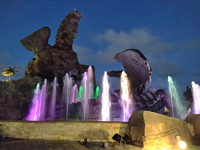 As darkness falls, colorful fountains dance at the statue's base, adding a Vegas-worthy light show to this roadside wonder.