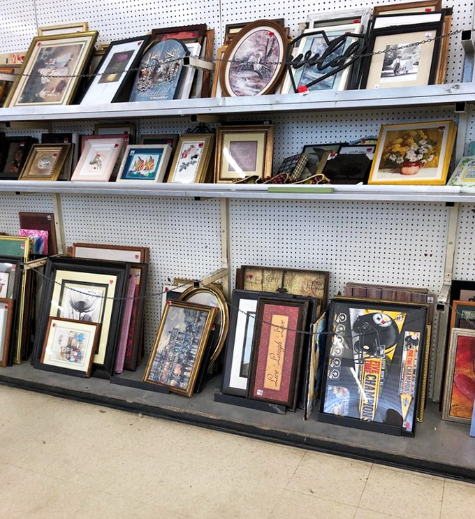 Framed artwork that once adorned someone else's walls now waits for a second chance. That Steelers print practically screams "Pittsburgh!"