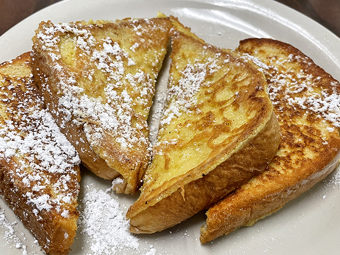 French toast dusted with powdered sugar like a light Texas snowfall&mdash;crisp edges, custardy centers, and a perfect vehicle for maple syrup rivers.