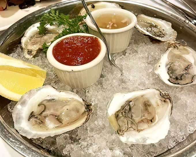 Fresh oysters nestled in ice like pearls in a frozen sea, waiting to deliver that perfect briny kiss of the ocean.