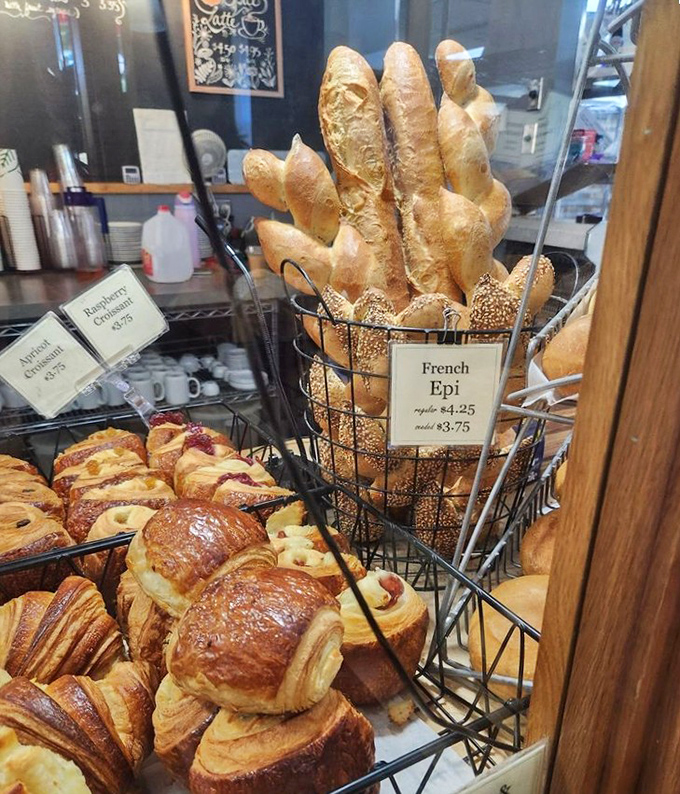 French baguettes standing at attention like delicious sentinels guarding a kingdom of pastry treasures.