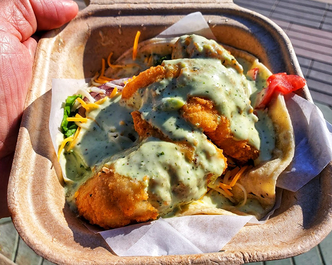 This isn't just a fish taco; it's a masterclass in texture and flavor, where crispy meets creamy in a handheld celebration of the sea.