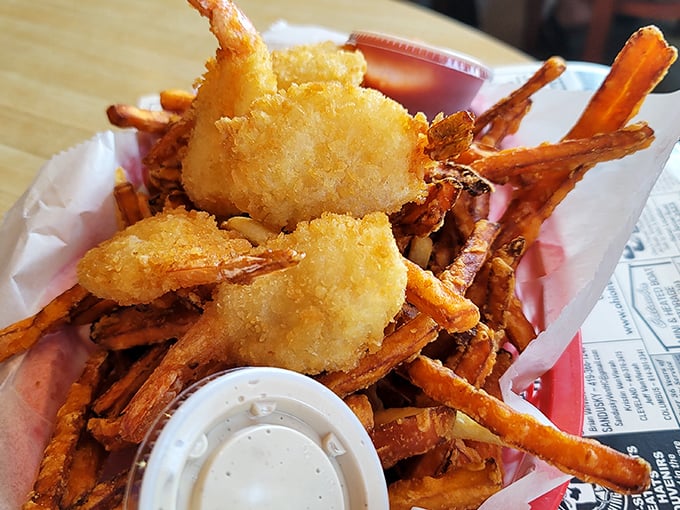 Golden-battered shrimp nestled among sweet potato fries &ndash; proof that sometimes the best vacation memories come served in a paper-lined basket.