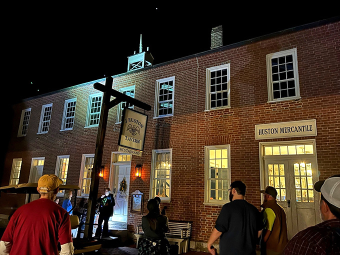J. Huston Tavern glows with nighttime mystery, drawing visitors like moths to a flame of history and hospitality.