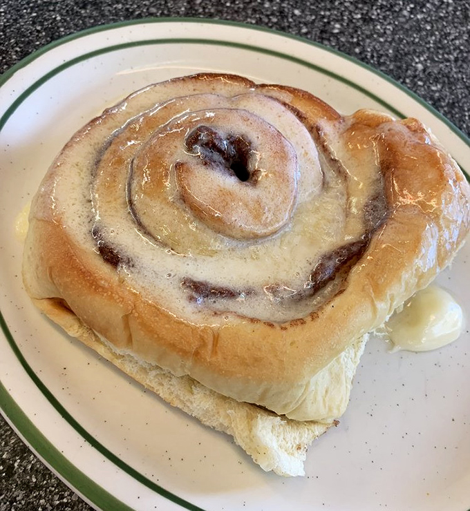 This cinnamon roll isn't just breakfast&mdash;it's an event. That glaze isn't merely dripping&mdash;it's performing a slow, sweet ballet across warm, pillowy dough that took hours to perfect.