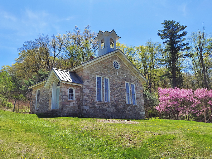 Storybook charm in stone and steeple. This quaint church, framed by spring blossoms, looks like it was plucked from a Currier and Ives print.