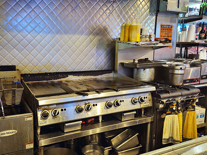 Where breakfast magic happens – a well-seasoned flat top grill that's seen more eggs than an Easter bunny convention.