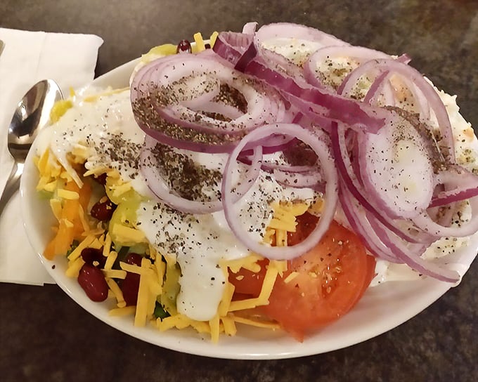 A garden on a plate! This salad loaded with cheese, tomatoes, and perfectly sliced red onions proves vegetables can be the main attraction.