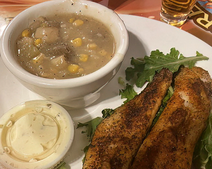 Comfort in a bowl&mdash;hearty soup alongside what appears to be a perfectly seasoned sandwich, with tzatziki sauce standing by for dipping duty.