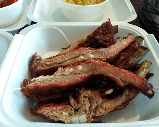 Ribs with that perfect pink smoke ring&mdash;visual evidence of the low-and-slow cooking method that defines great barbecue.