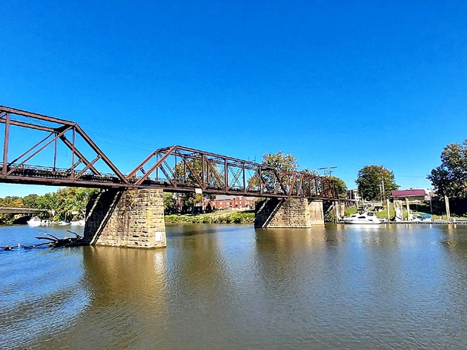 The Historic Harmar Bridge connects past and present, its weathered iron frame standing strong against time and the flowing Muskingum below.