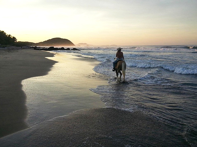 Horseback riding along the water's edge &ndash; when walking on the beach simply isn't magical enough.