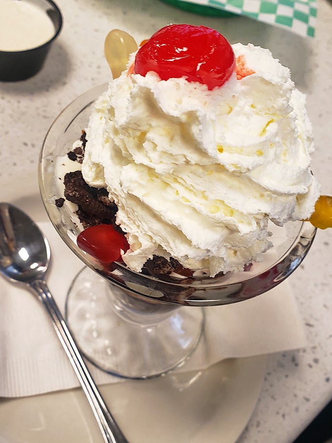 This hot fudge sundae stands tall and proud, whipped cream mountain topped with a cherry beacon, calling your name.