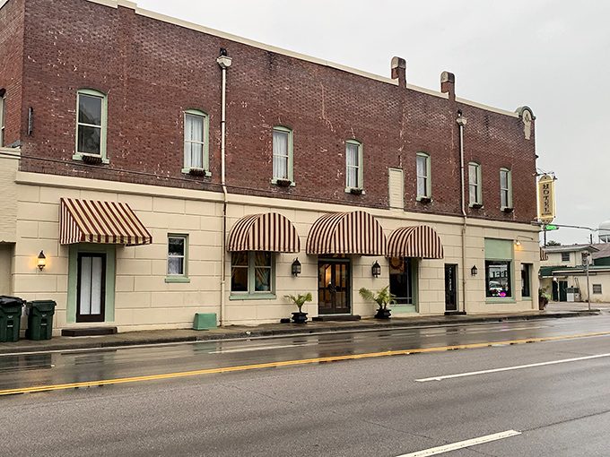Hotel DeFuniak's striped awnings and historic façade whisper tales of travelers past, offering a downtown anchor that's equal parts charm and character.