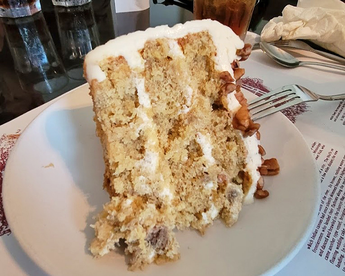 This isn't just cake—it's a towering achievement of what appears to be hummingbird cake, with layers that demand to be studied before being devoured.