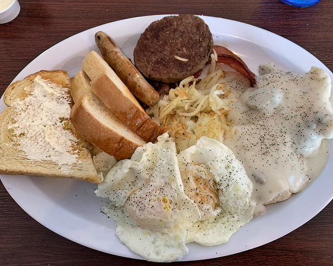 JJ's Special omelet draped in country gravy alongside perfectly crisped hash browns&mdash;a breakfast worth setting your alarm for, even on weekends.