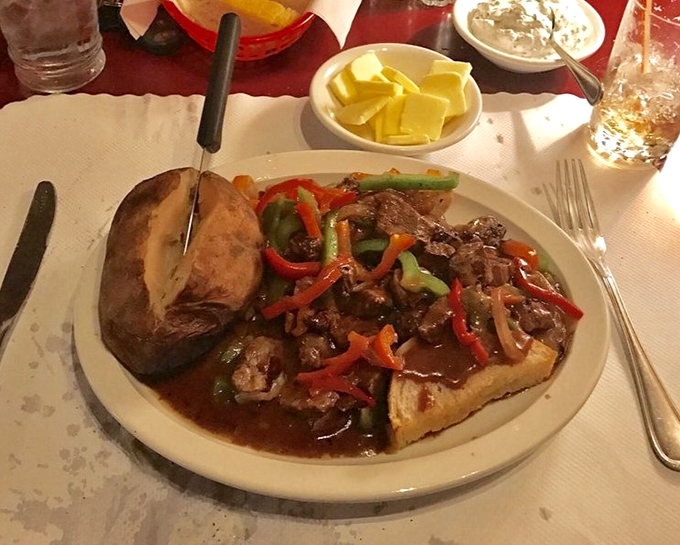 Jack's Stack isn't just dinner; it's a meaty monument to excess done right&mdash;saut&eacute;ed steak medley over garlic bread that demands to be photographed.