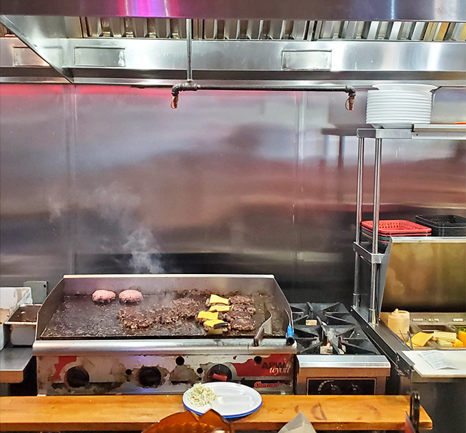 Behind the scenes, burgers sizzle on the griddle while steam rises like delicious clouds announcing lunch is almost ready for hungry souls.