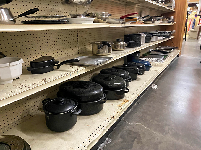 Cast iron cookware lines the shelves like culinary heirlooms, each seasoned pan holding decades of family dinners and Sunday breakfasts.