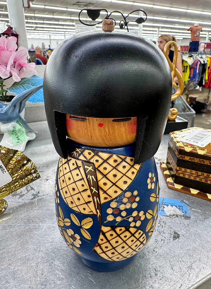 The Japanese kokeshi doll waits patiently among the bric-a-brac, a cultural ambassador in this United Nations of secondhand treasures.