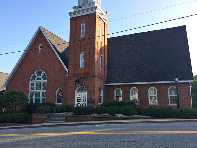 The Methodist Church's brick tower reaches skyward, a spiritual landmark that's been witnessing Sunday best outfits for generations.