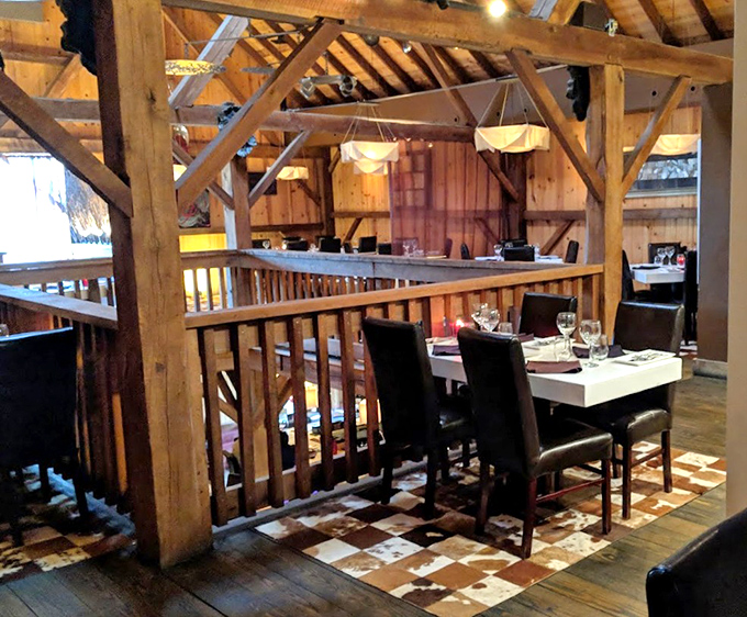 The multi-level dining space showcases original barn architecture&mdash;where each wooden beam could tell stories of harvests past and steaks present.
