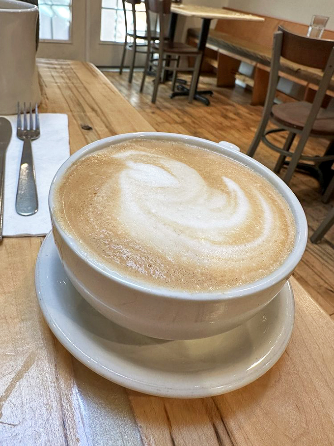 Coffee elevated to art form. This latte's foam swirl is the kind of morning masterpiece that makes you pause before that first, perfect sip.