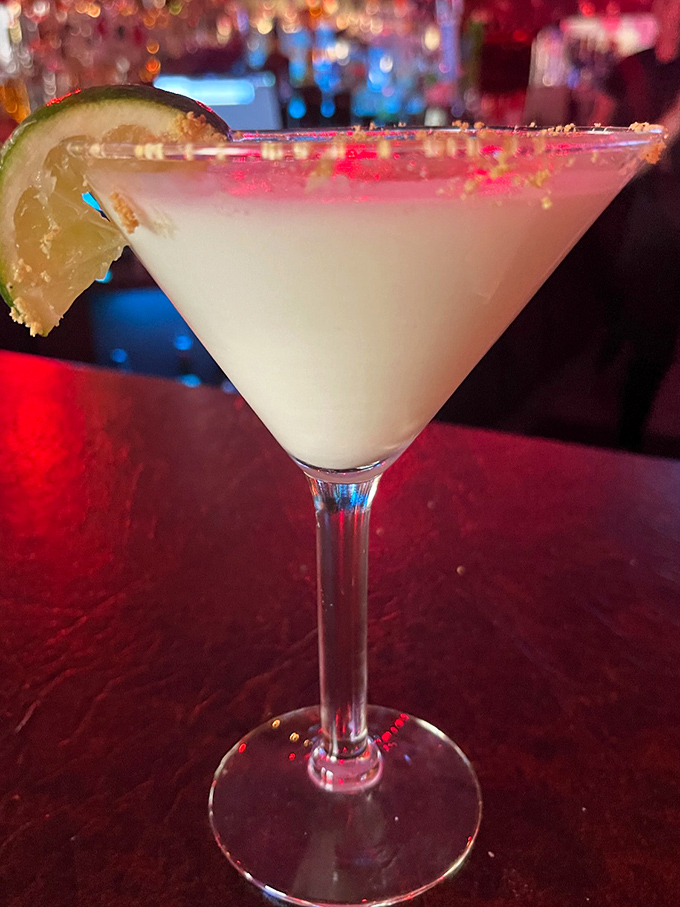 A martini so pristine it belongs in a museum. The lime wedge is just there to remind you this is a drink, not a work of art.