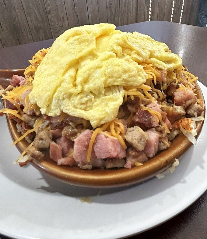 This meat lover's skillet doesn't just feed you; it tells a story of heartland abundance topped with a fluffy egg epilogue.