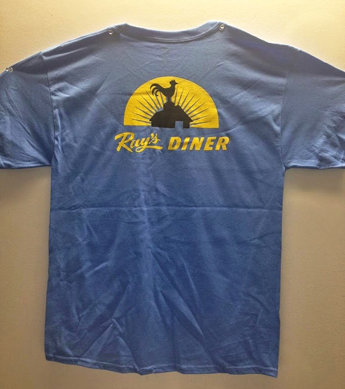 The unofficial uniform of diner devotees. Ray's blue t-shirt with rooster logo&mdash;the souvenir that proves you're in the know.