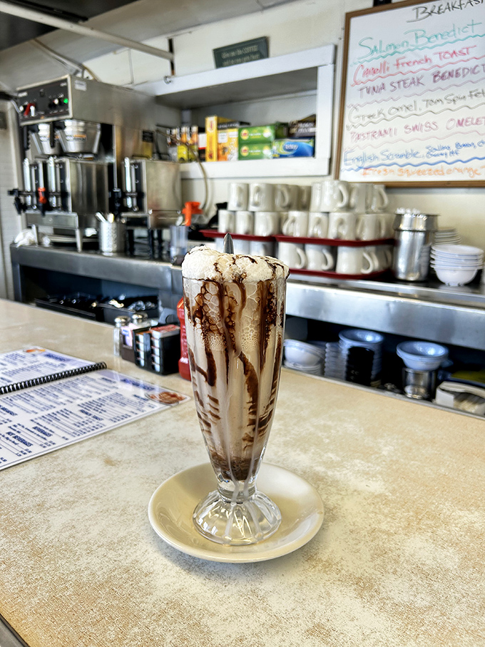 Not just a milkshake, but a work of art—chocolate drizzles creating a Jackson Pollock masterpiece you can actually consume without museum security intervening.
