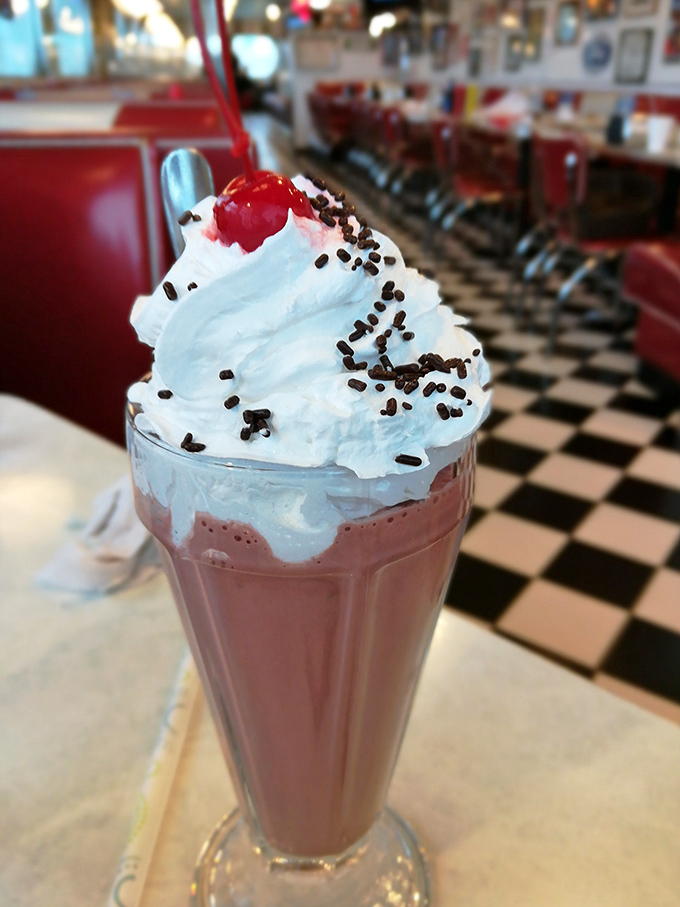 This isn't just a milkshake &ndash; it's a towering pink masterpiece topped with whipped cream, sprinkles, and a cherry that would make the Fonz give two thumbs up.