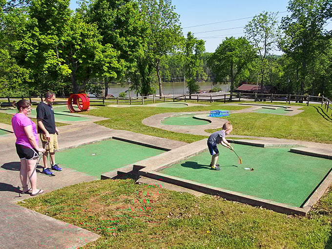 Family mini-golf in action &ndash; where competitive spirits emerge, putting skills are questionable, and laughter is the real hole-in-one.