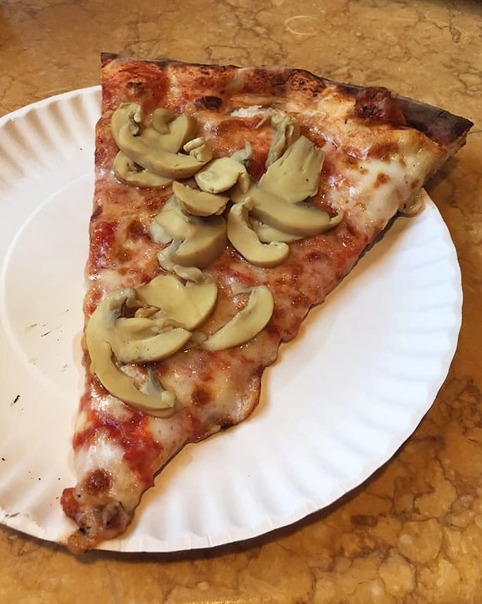 Mushrooms arranged with the care of a Renaissance painter. Fungi never found a more perfect home than atop this slice.