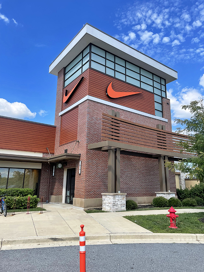 The Nike tower stands like a retail lighthouse, guiding the athletically-inclined toward discounted swoosh-emblazoned treasures.