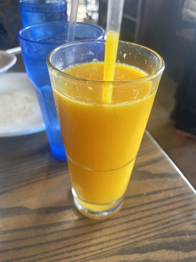 Fresh-squeezed orange juice in a glass that remembers when breakfast was a sit-down affair, not a drive-through sprint.