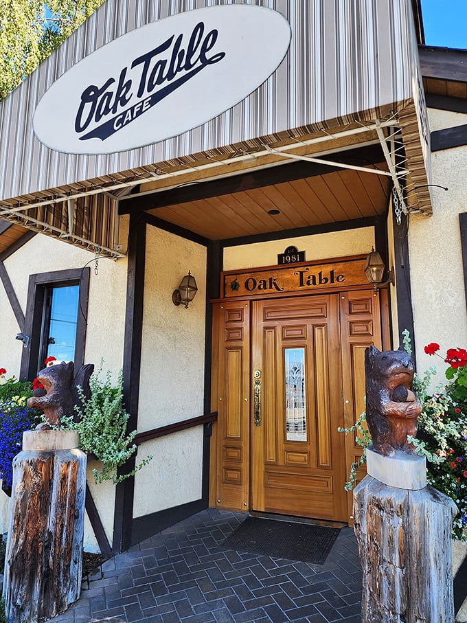 Oak Table Cafe's entrance, guarded by wooden bears who've clearly sampled too many of those famous apple pancakes.