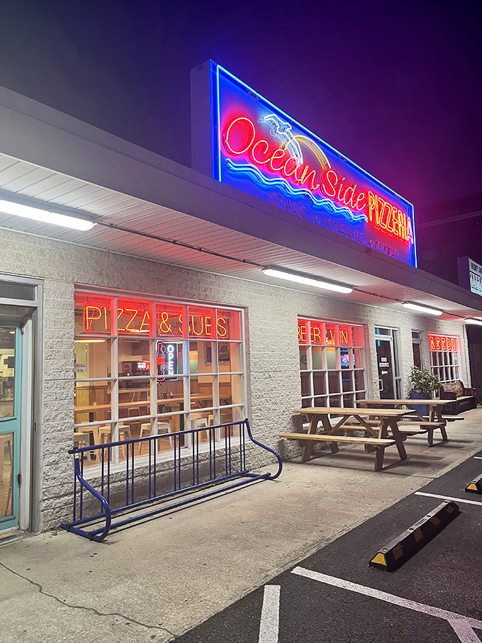 Oceanside Pizza's neon glow beckons hungry beachgoers after dark. Nothing tastes quite like pizza after a day of salt air and sunshine.