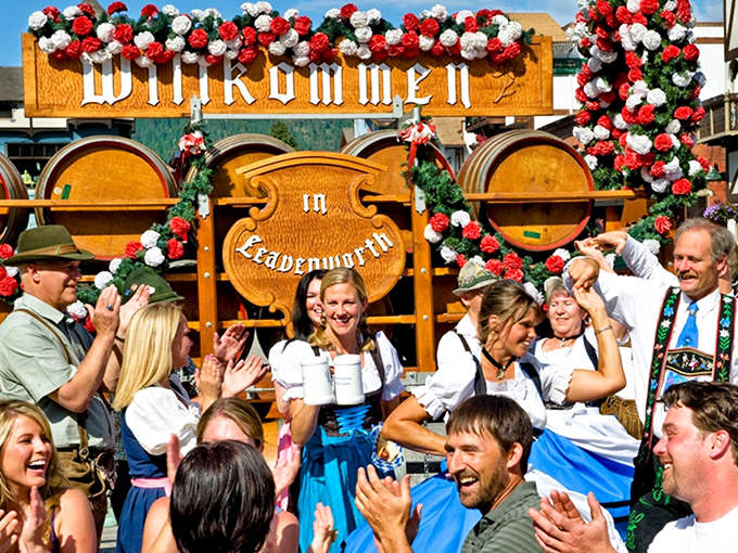 "Willkommen in Leavenworth" announces the festival sign, surrounded by traditionally-dressed revelers whose smiles suggest the beer is flowing generously.