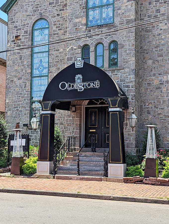 Oldestone's elegant entrance promises sophisticated dining behind those impressive stone walls. The stained glass windows hint at the artistry waiting inside.